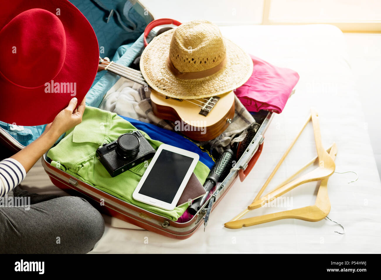 Woman hand packing a luggage for a new journey and travel for a long ...