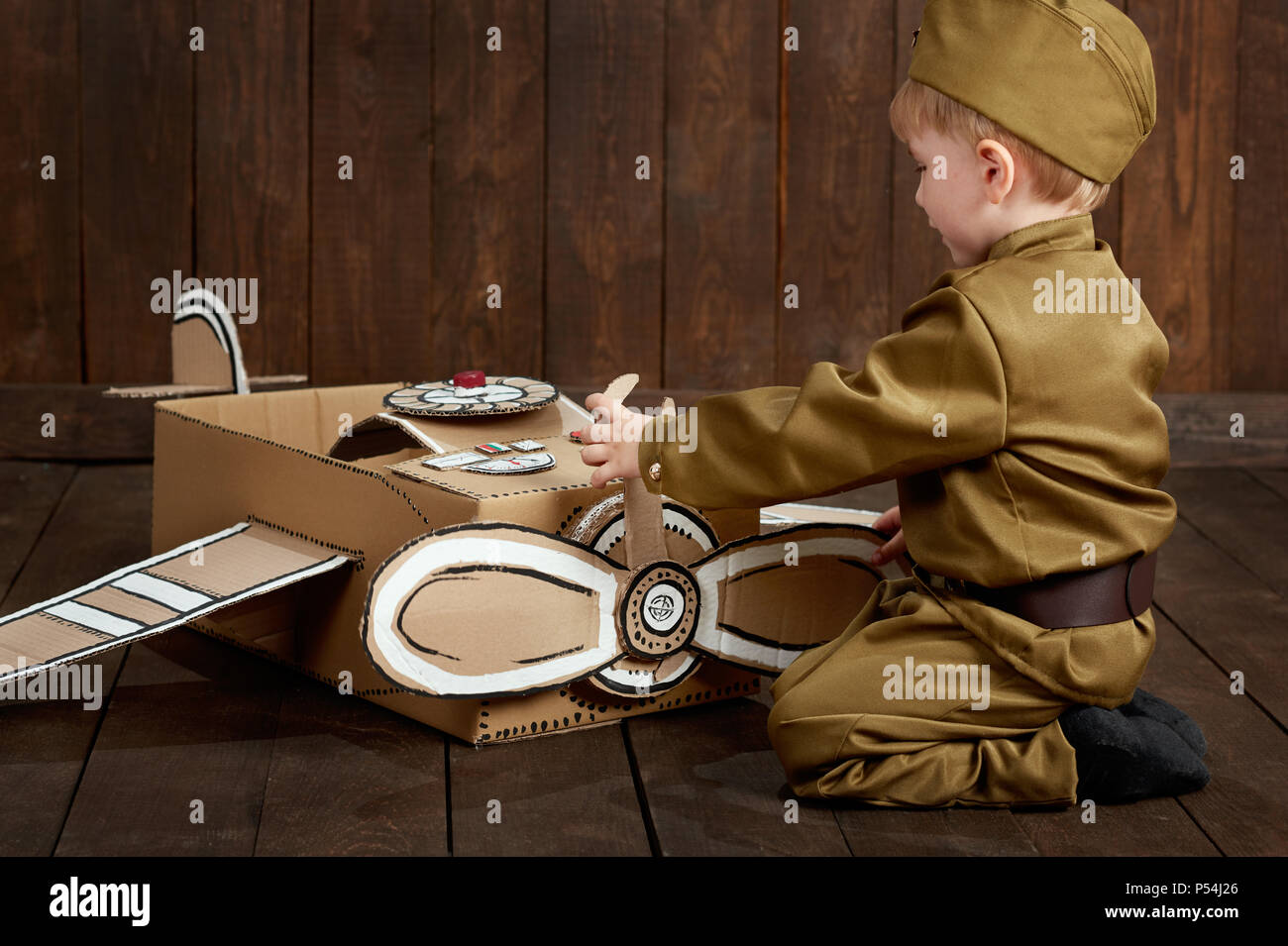 children boy are dressed as soldier in retro military uniforms repair ...