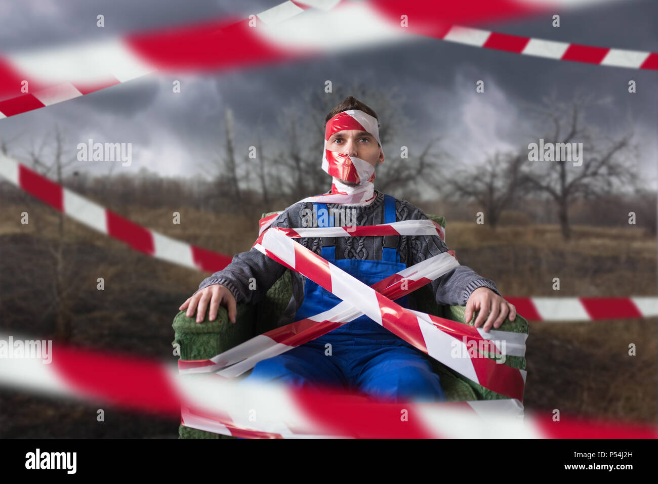 Autistic wrapped in crime-scene tape sitting in the middle of the field ...