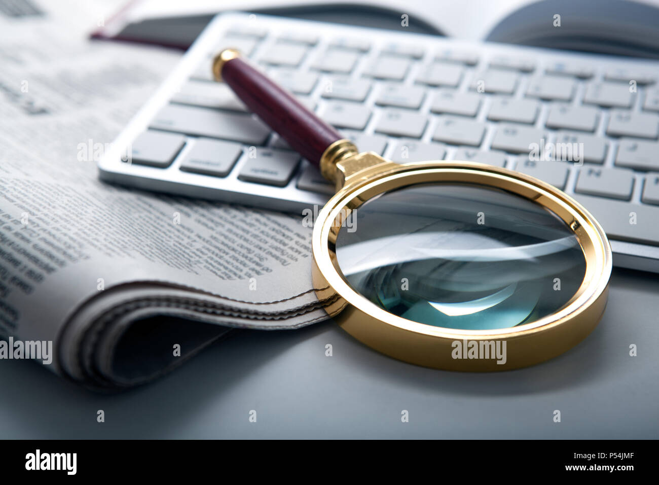 Computer magnifying glass newspaper hi-res stock photography and images ...