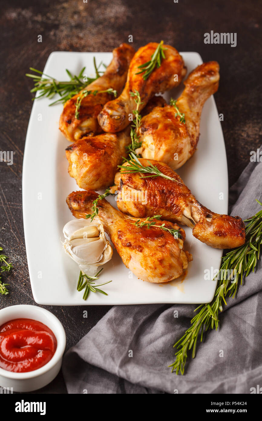 Grilled spicy chicken legs baked with garlic, rosemary and thyme in ...