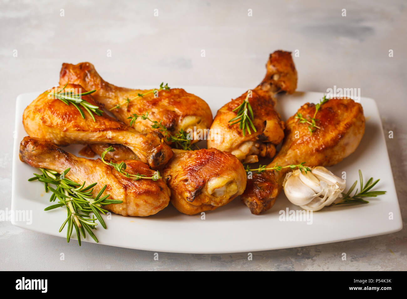 Grilled spicy chicken legs baked with garlic, rosemary and thyme in ...