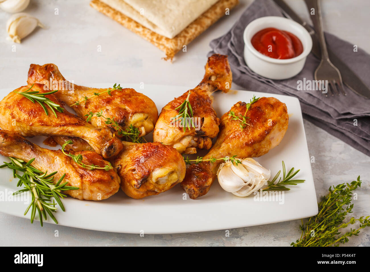 Grilled spicy chicken legs baked with garlic, rosemary and thyme in ...