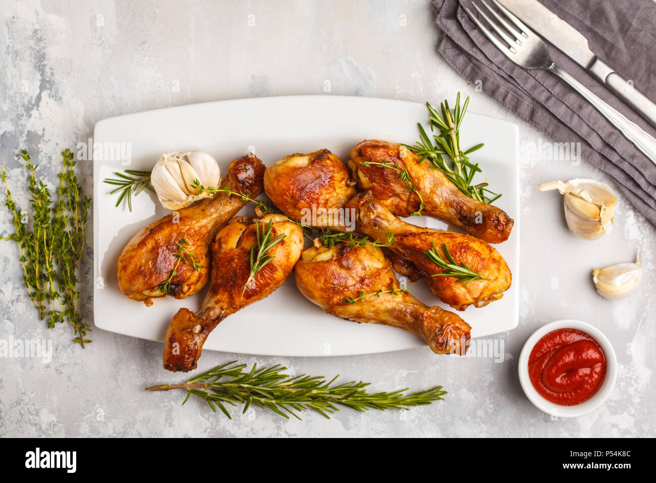 Grilled spicy chicken legs baked with garlic, rosemary and thyme in ...