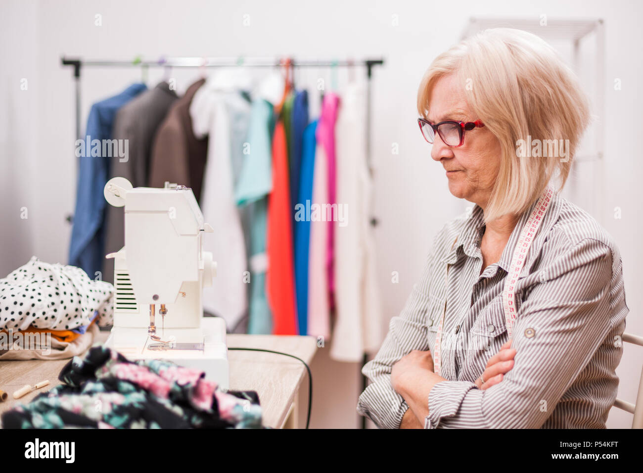 Adult woman is sewing in her studio and having issues with sewing ...