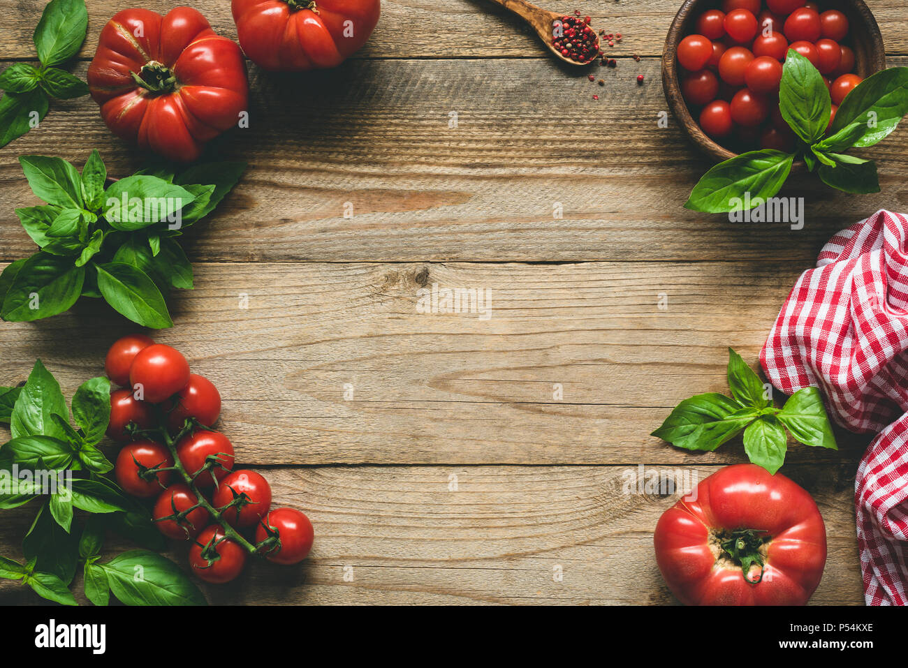 Rustic food background. Heirloom tomatoes, spices and basil on wood ...