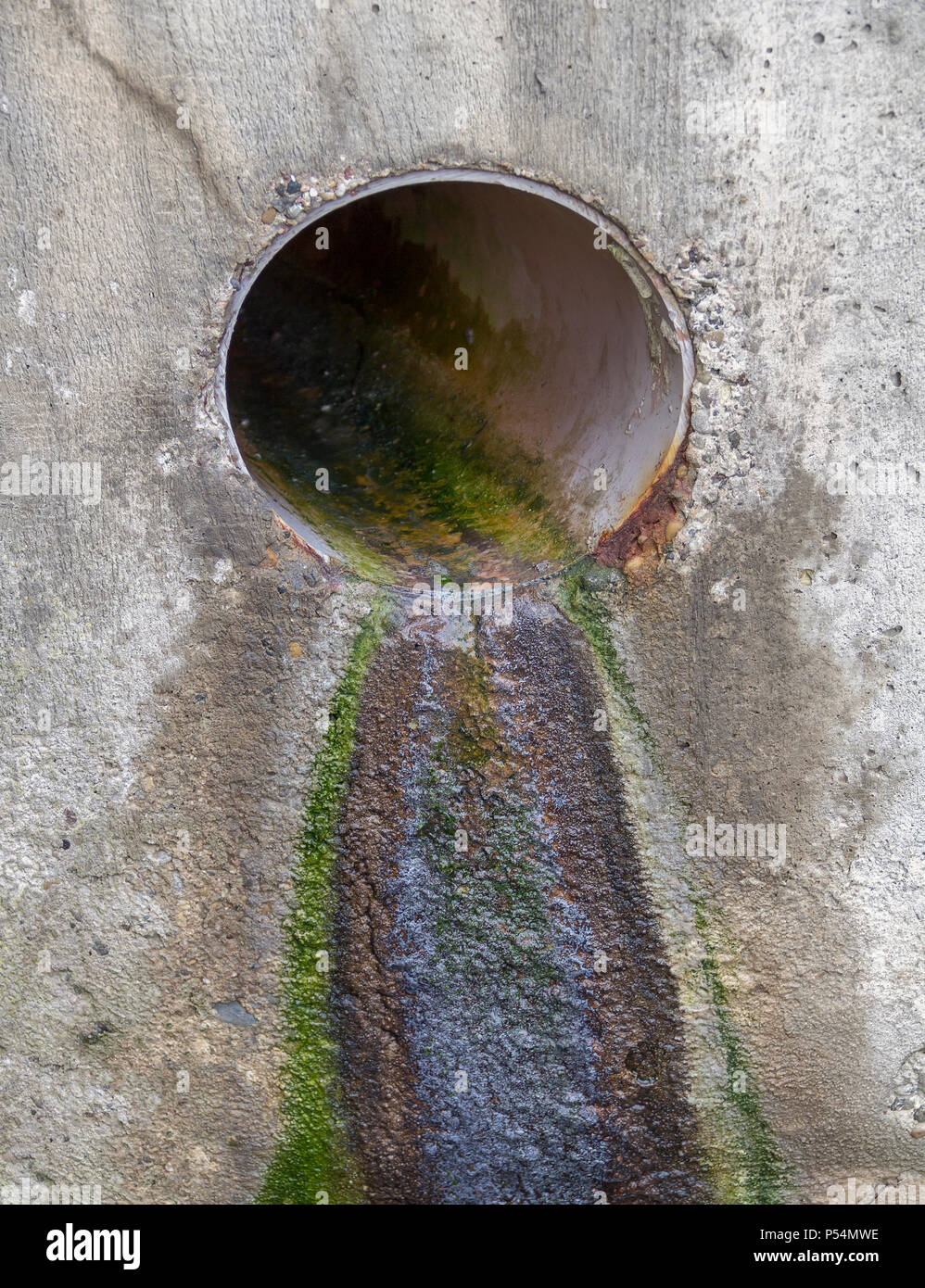 pollution theme showing the end of a waste pipe and flowing water ...