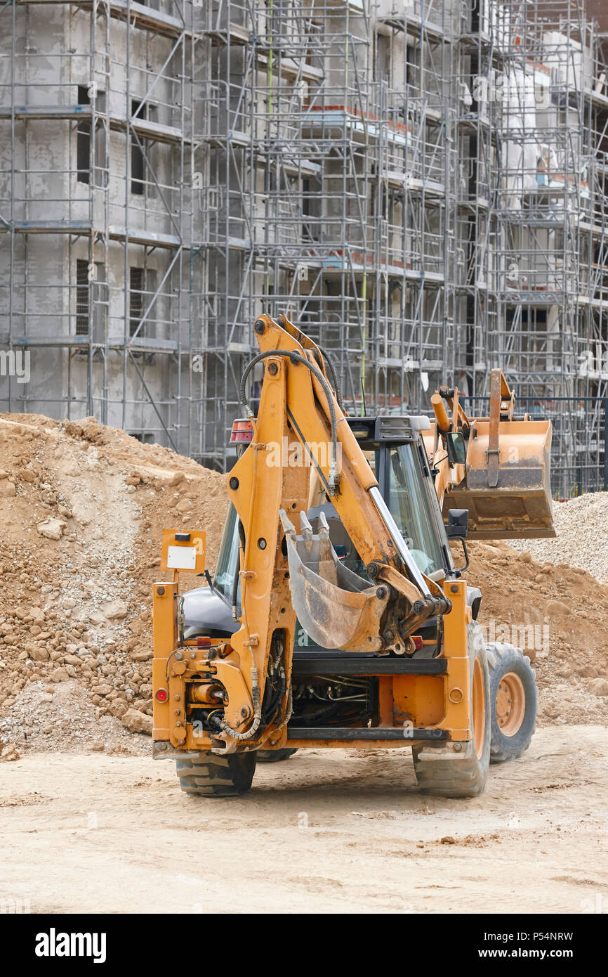 Excavator on a construction site. Building in progress. Architecture ...