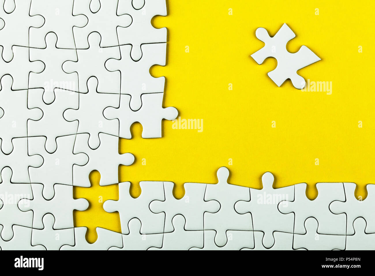 White details of puzzle on yellow background Stock Photo - Alamy