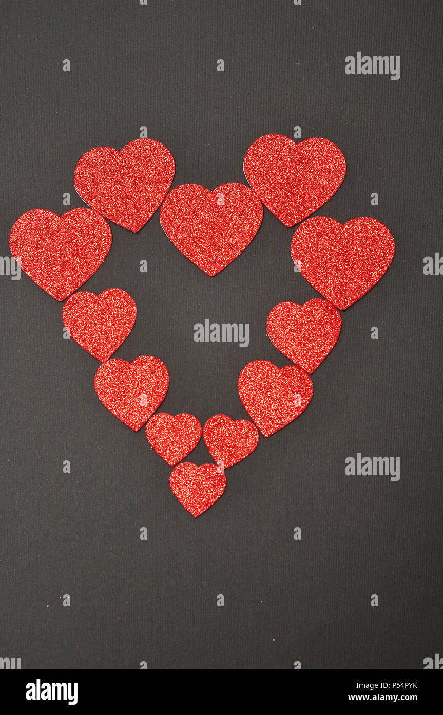 A heart made out of different size hearts on a black background Stock ...