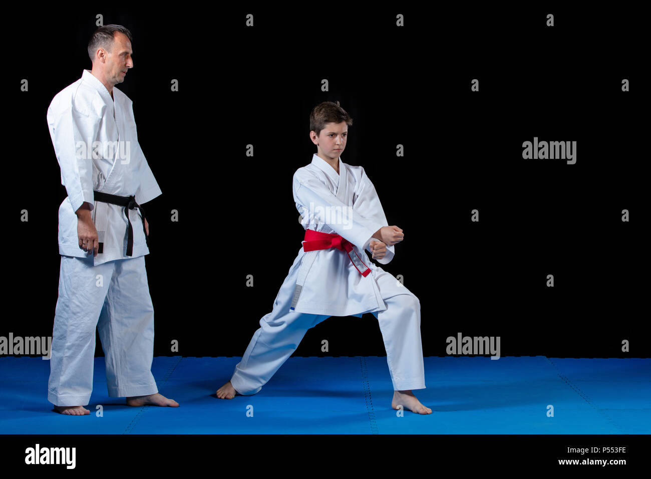 Male karate instructor training little children in dojo Stock Photo - Alamy
