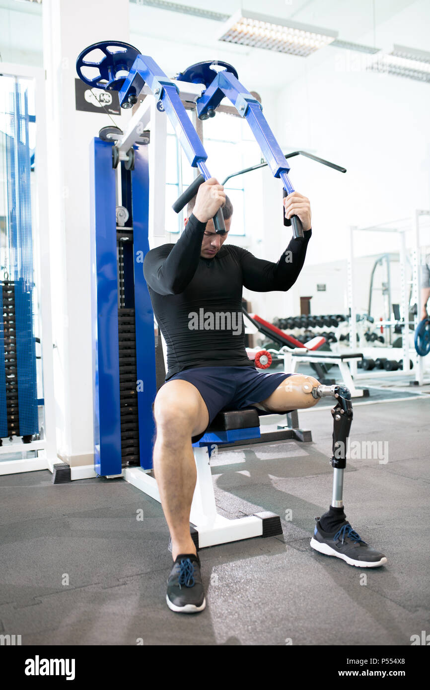 Adaptive Sportsman Using Exercise Machines in Gym Stock Photo - Alamy