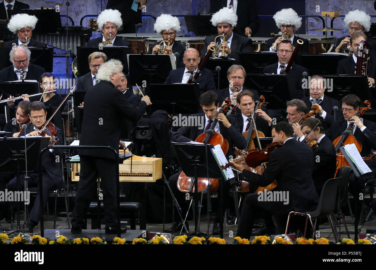 Berlin, Germany. 24th June, 2018. Sir Simon Rattle conducting musicians, some of whom are ...