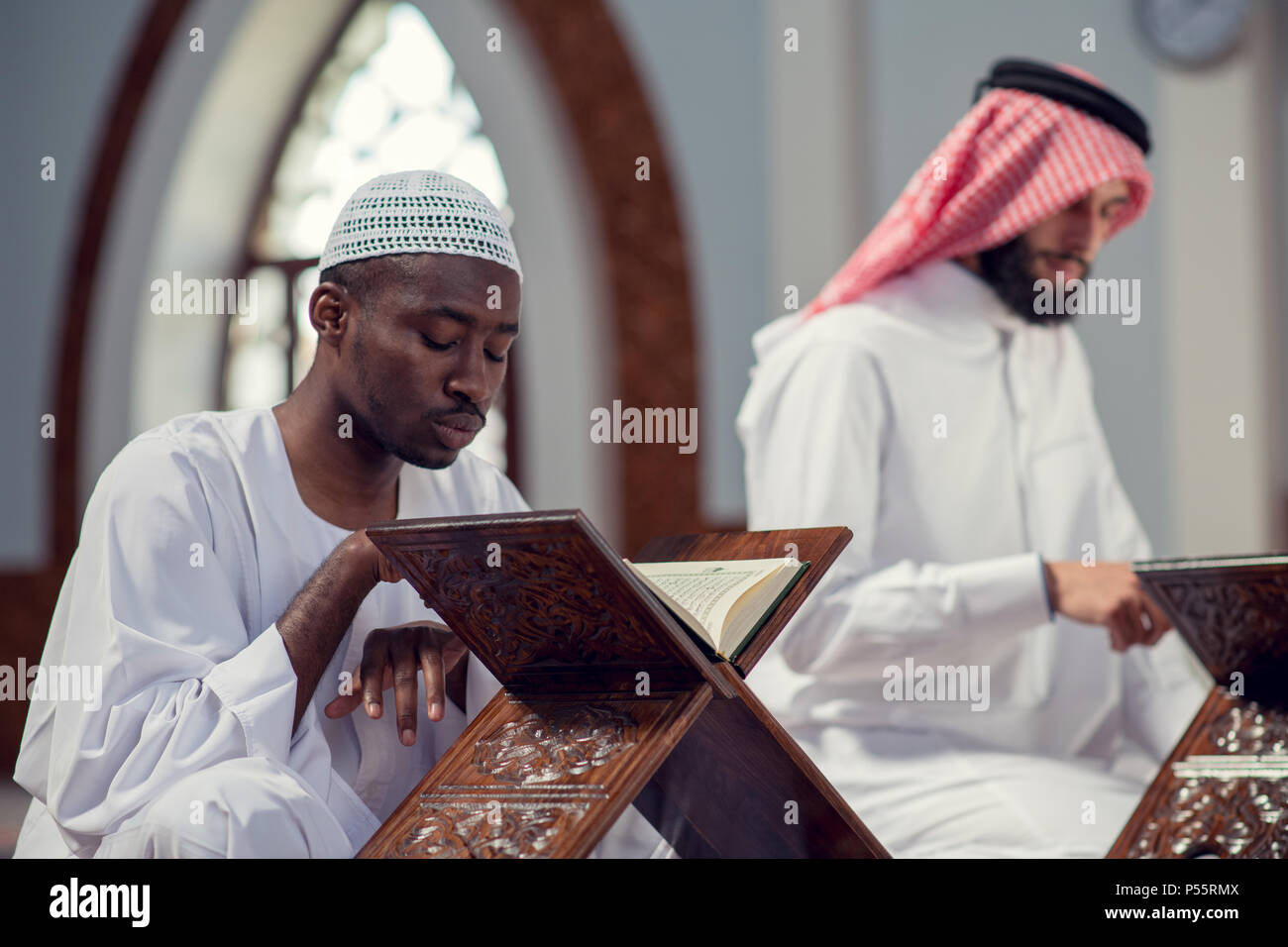 Two religious muslim man praying together inside the mosque Stock Photo ...
