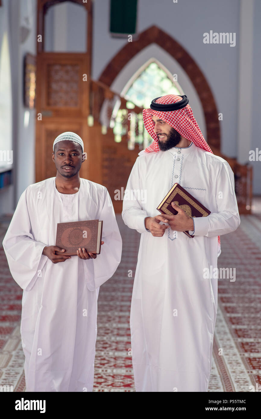Two religious muslim man walking together inside the mosque Stock Photo ...