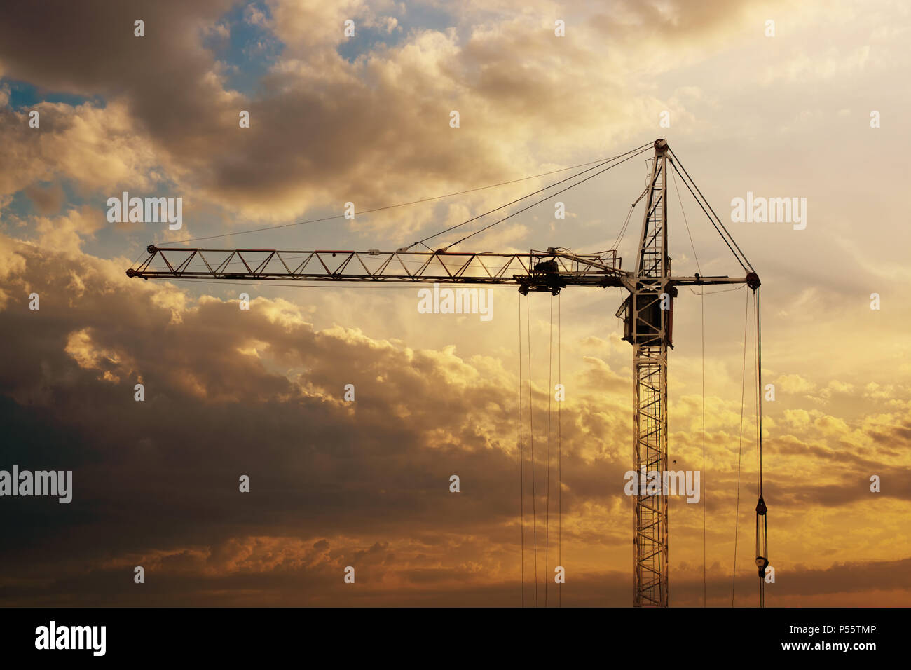 Tower crane on a construction site at sunrise Stock Photo - Alamy