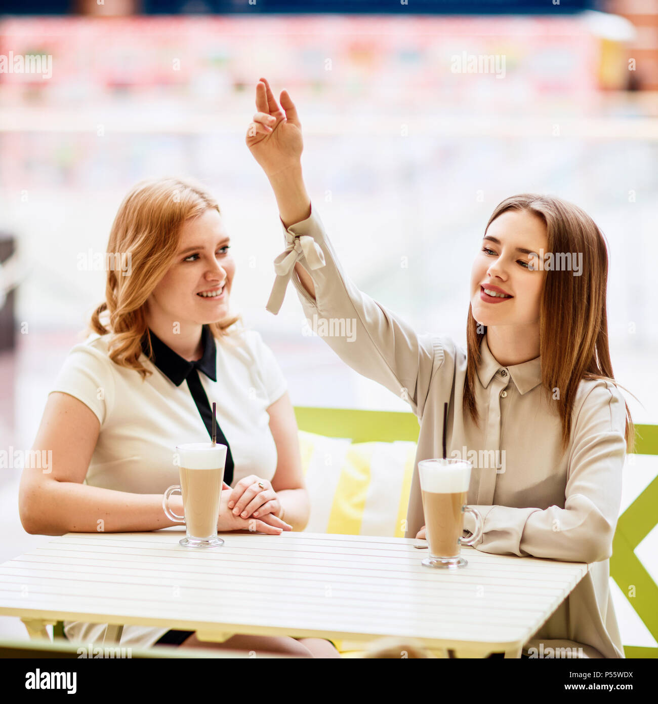 Two young beautiful caucasian female friends talking in the cafe Stock ...