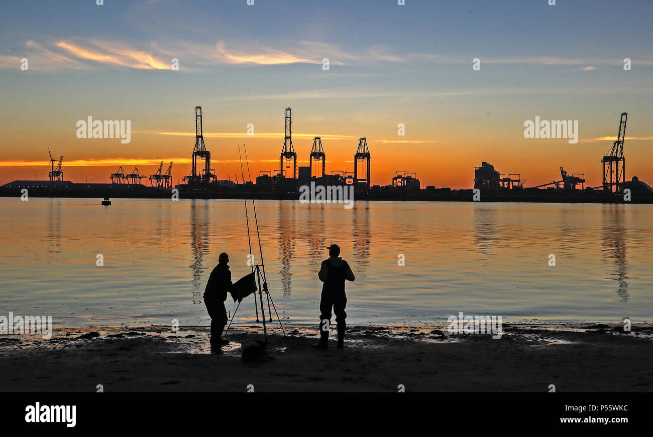 Anglers fish on New Brighton beach on the Wirral, Merseyside as the sun ...