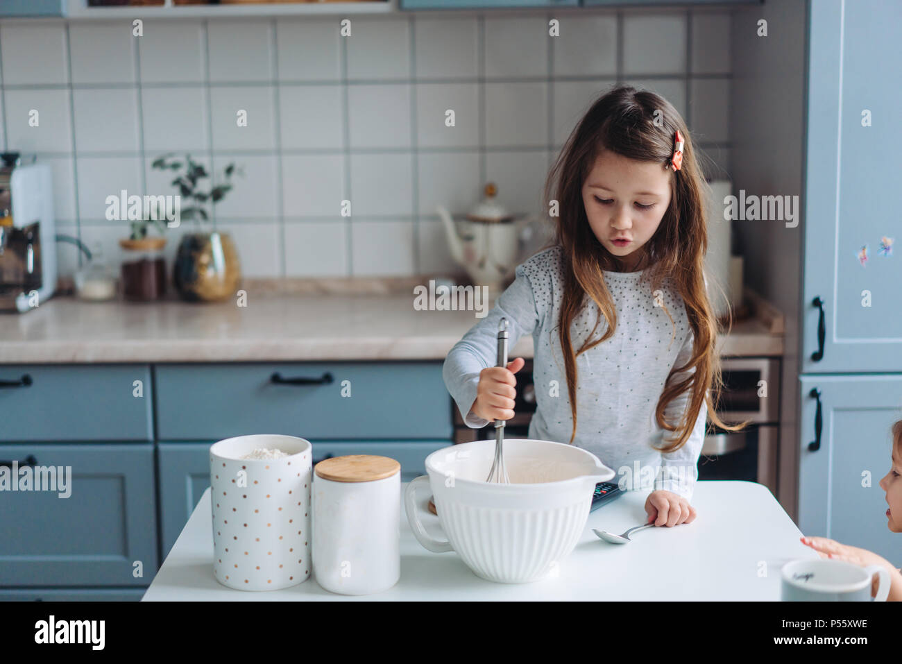 little girl cooks in the kitchen Stock Photo - Alamy