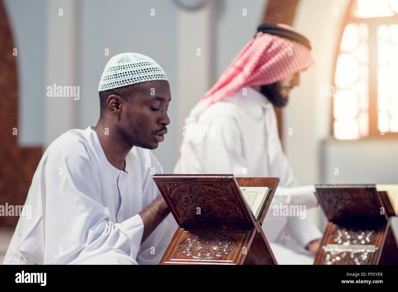 Two religious muslim man praying together inside the mosque Stock Photo ...