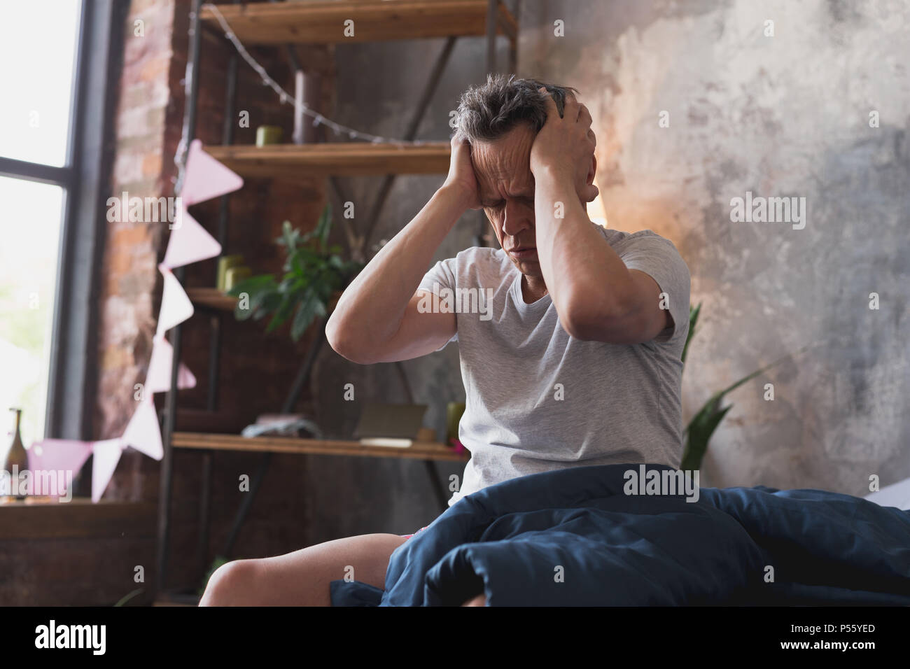 Painful mature man having headache Stock Photo - Alamy