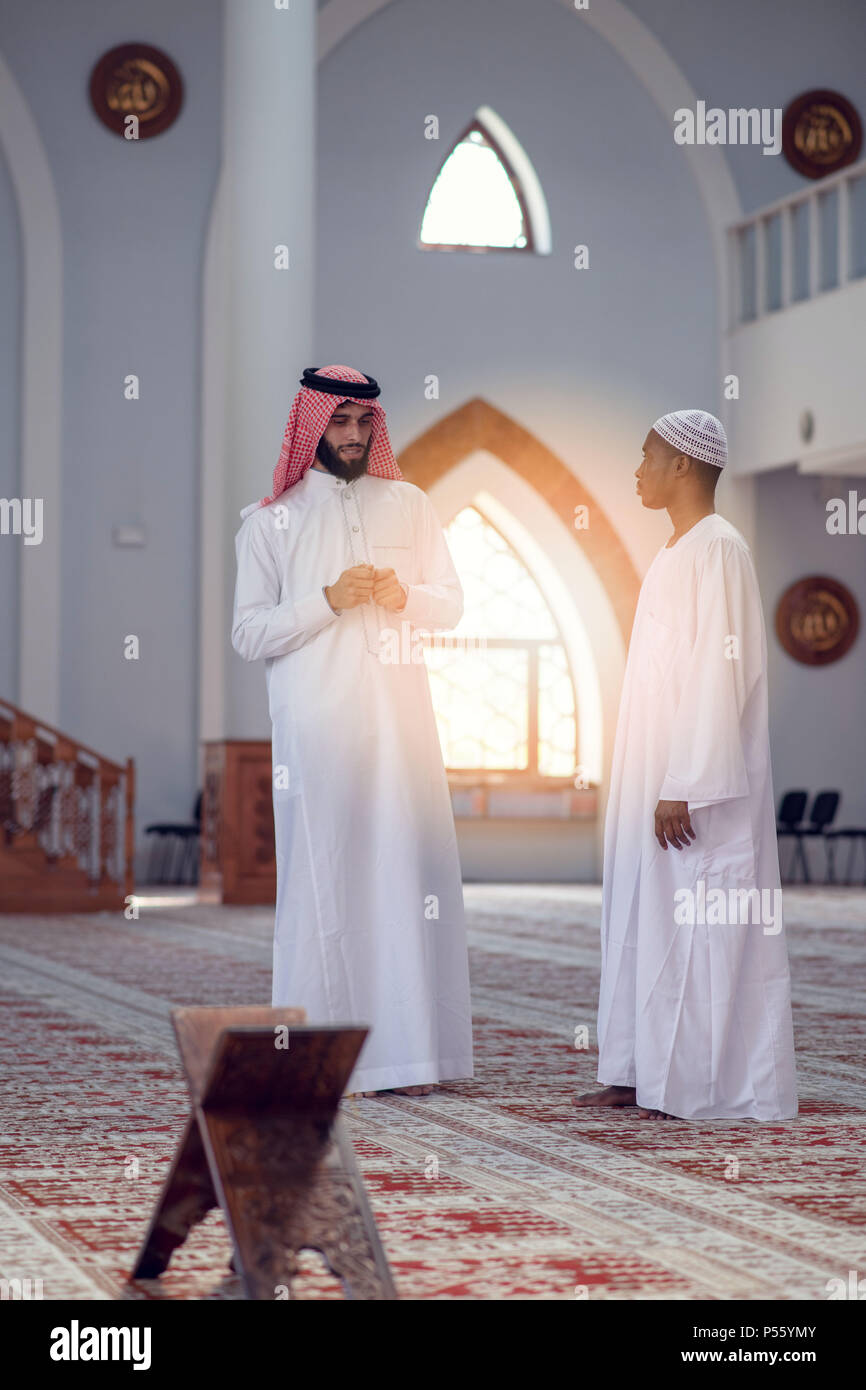 Two religious muslim man walking together inside the mosque Stock Photo ...