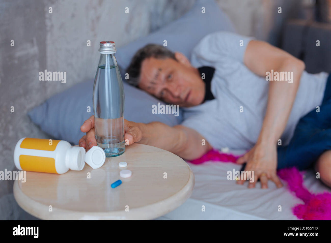 Sad mature man undergoing hangover Stock Photo - Alamy