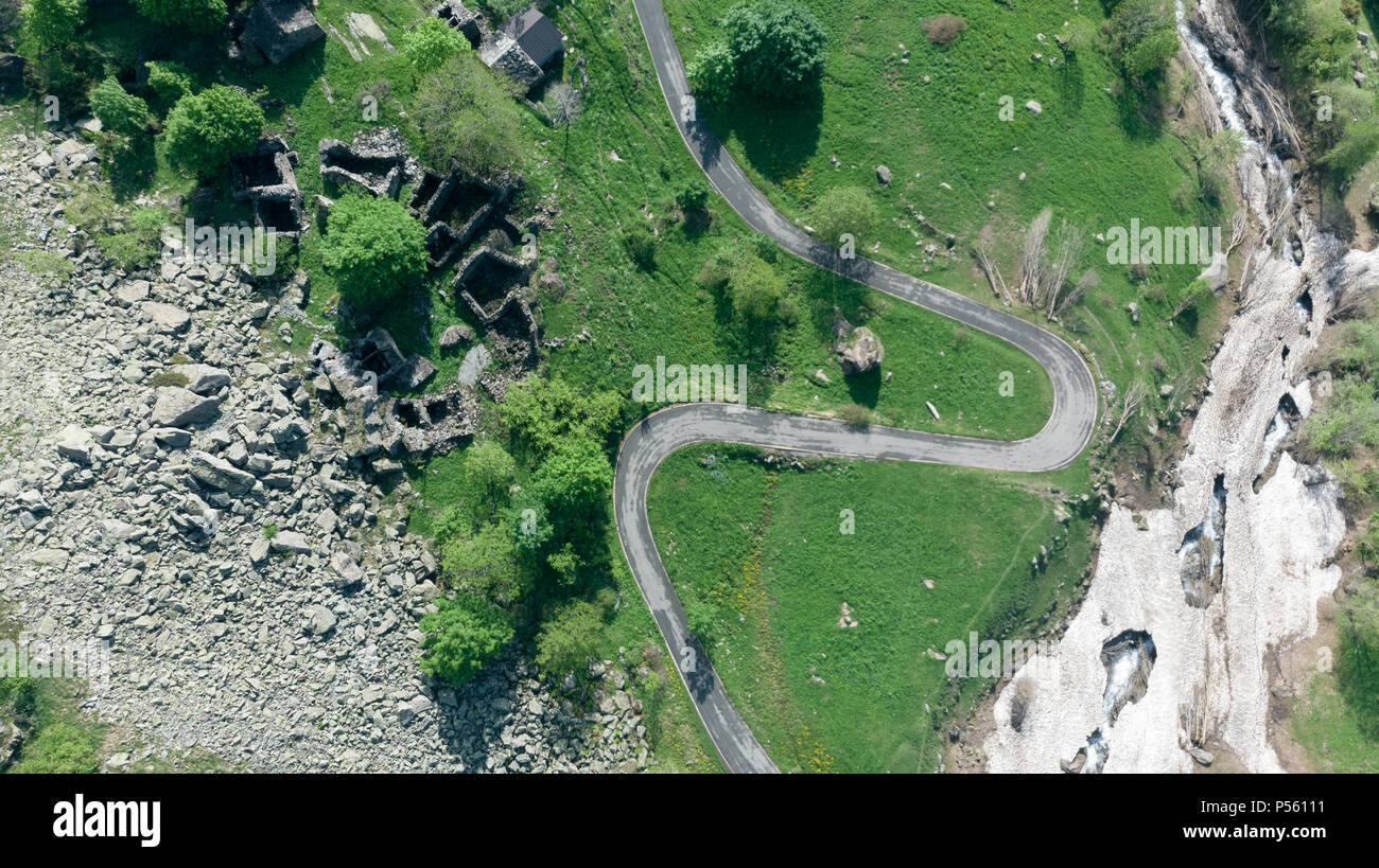 Aerial: top down view tailspin over winding mountain road on the ...