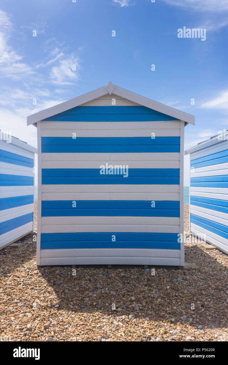Blue and white striped beach huts at the seaside Stock Photo - Alamy