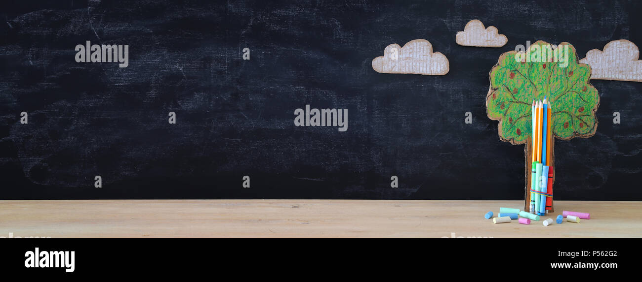 Back to school banner. tree of knowledge and pencils in front of ...