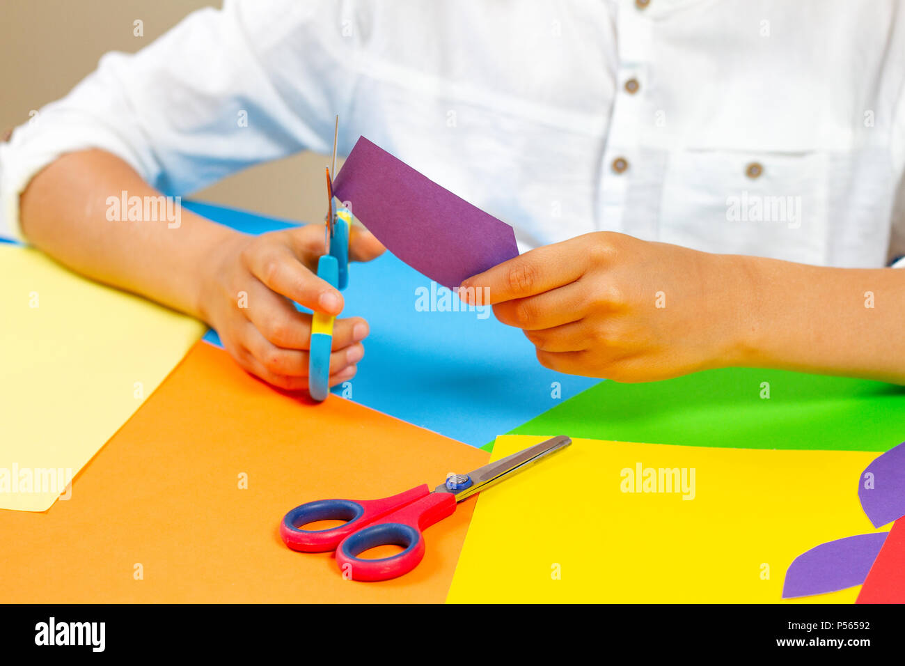 Elementary boy cutting paper scissors hi-res stock photography and ...