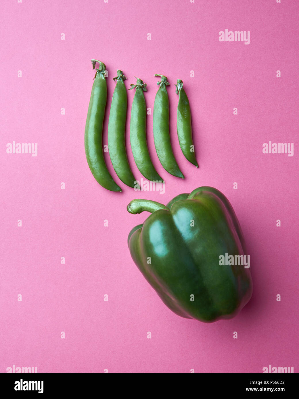 green pea pods and green sweet pepper on a pink background Stock Photo ...