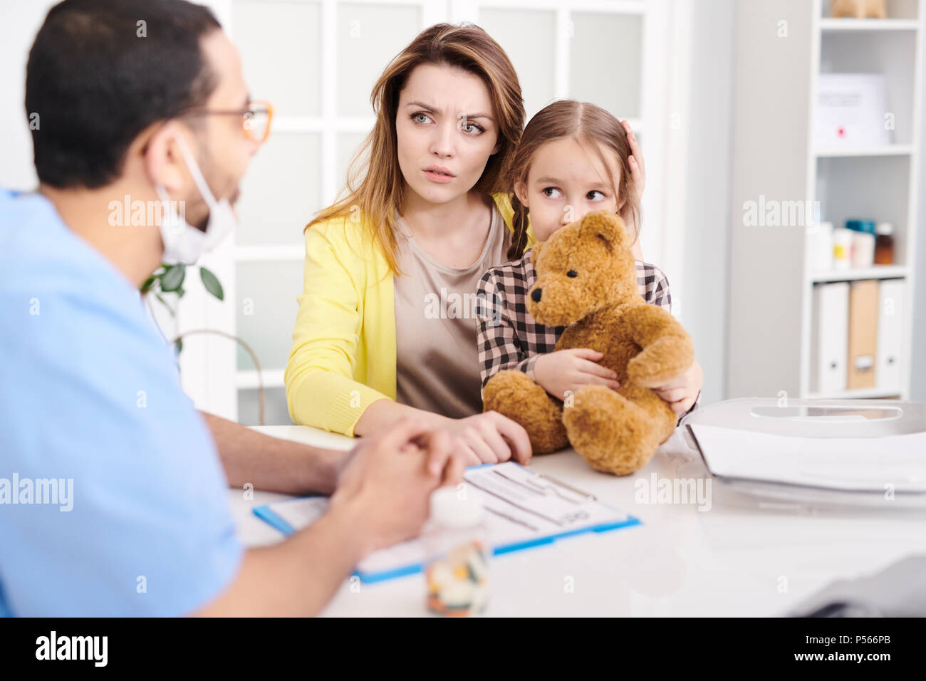 Concerned Mother in Doctors Office Stock Photo - Alamy