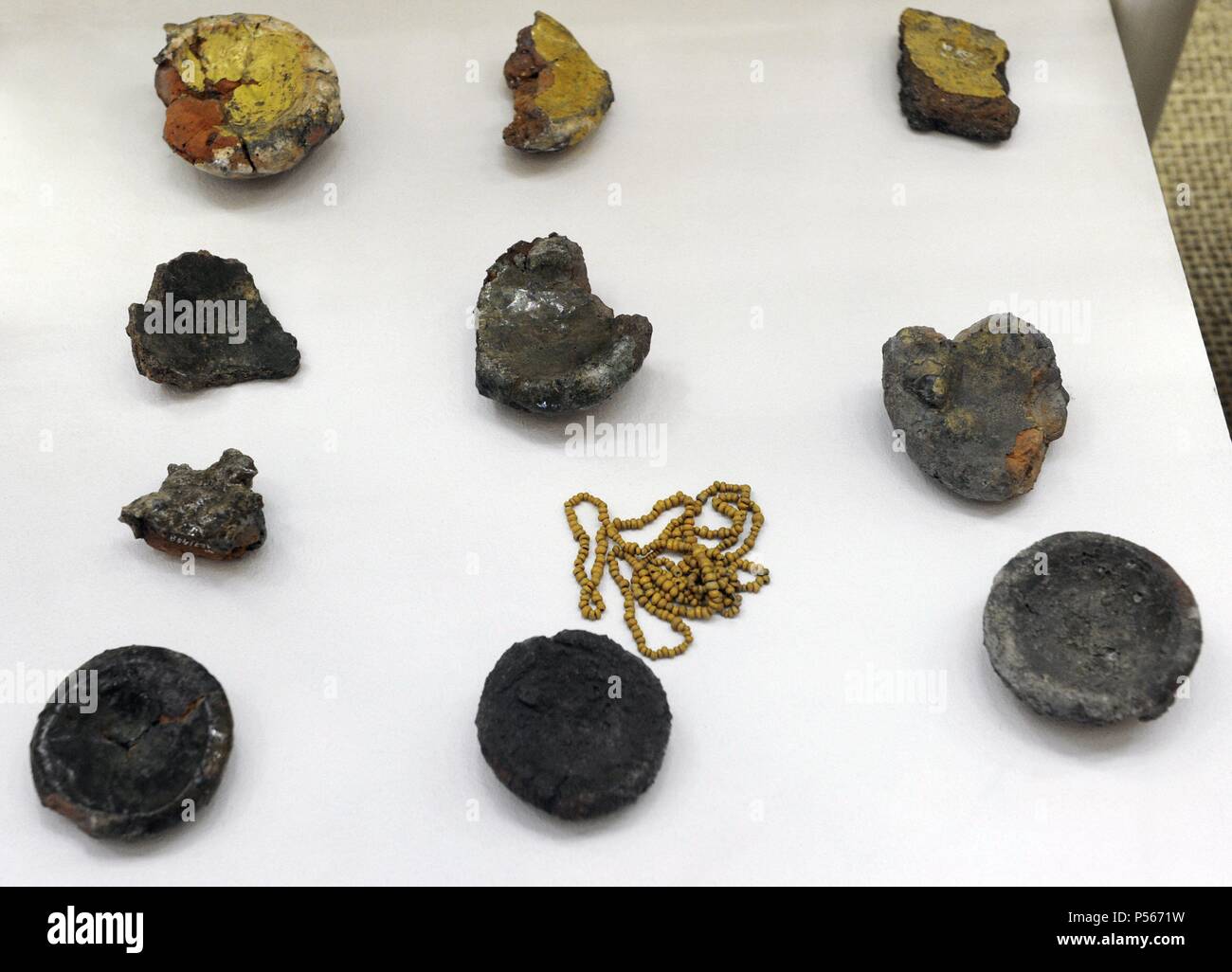 Remains of vitreous mass, clay's crucible and pearls. 13th century ...