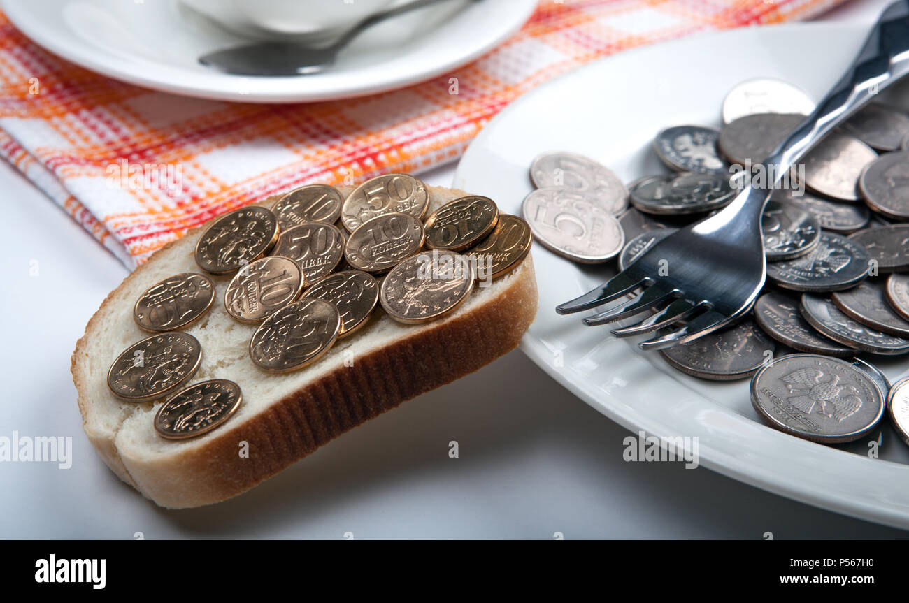 Plate with coins and a slice of bread with coins Stock Photo - Alamy