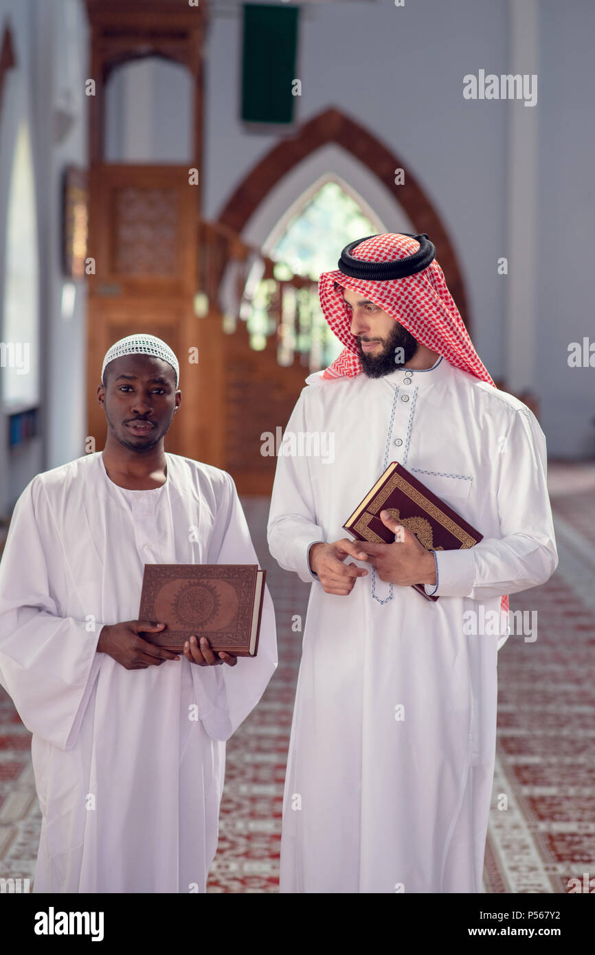 Two religious muslim man walking together inside the mosque Stock Photo ...