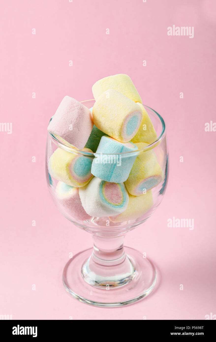 Colorful mini marshmallows in modern glass on pink background Stock ...