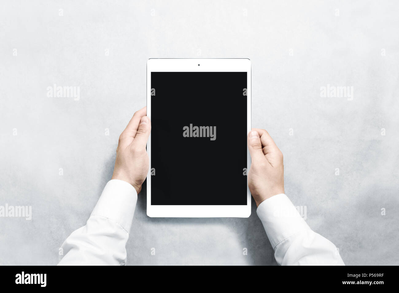 Hands holding blank vertical tablet mock up, new portable pc screen ...