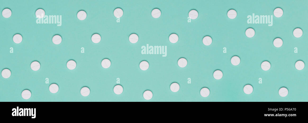 White pills on turquoise pastel colored background. Medication and ...