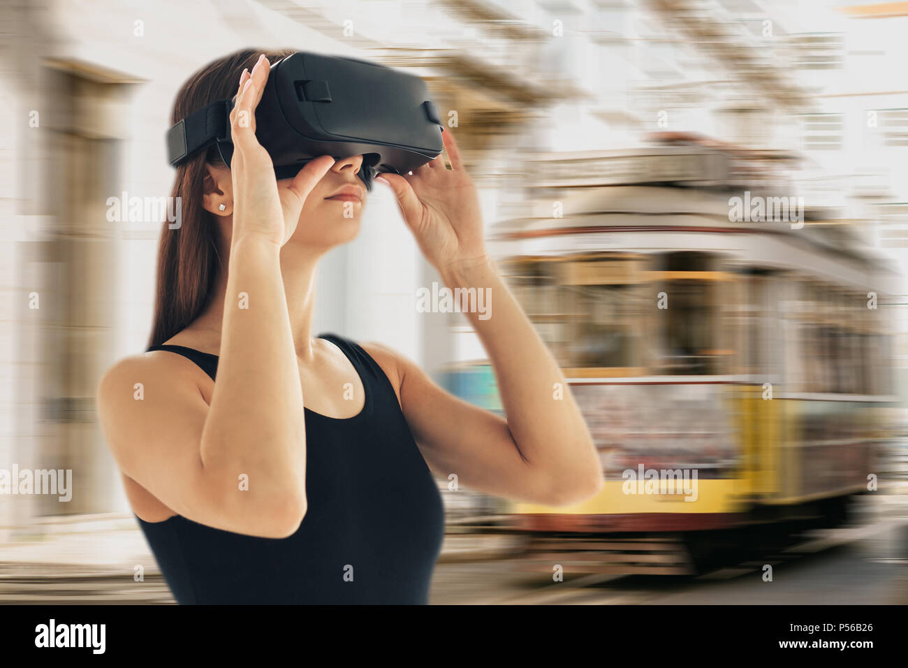 A young girl with virtual reality glasses or a virtual tourist or traveler. The concept of ...