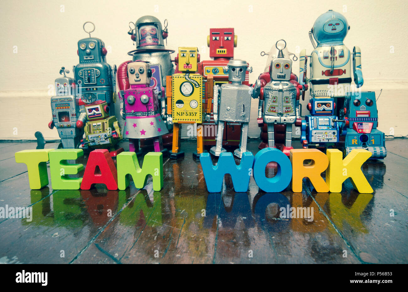 a team of vintage robots with the word TEAM WORK on a old wooden floor ...