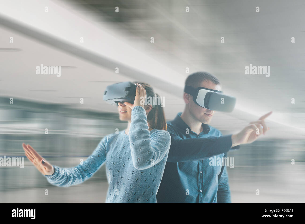 A young woman and a young man in virtual reality glasses.The concept of ...