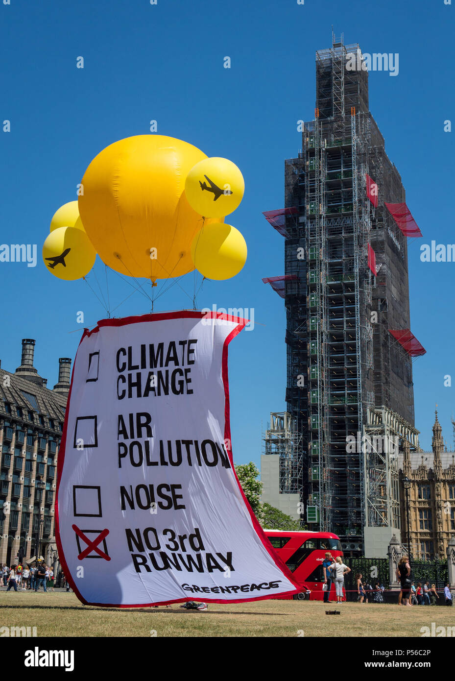 Greenpeace activists fly a banner in Parliament Square, London, as they ...