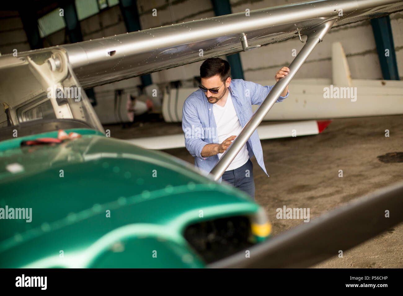 Male pilot checking airplane wing hi-res stock photography and images ...