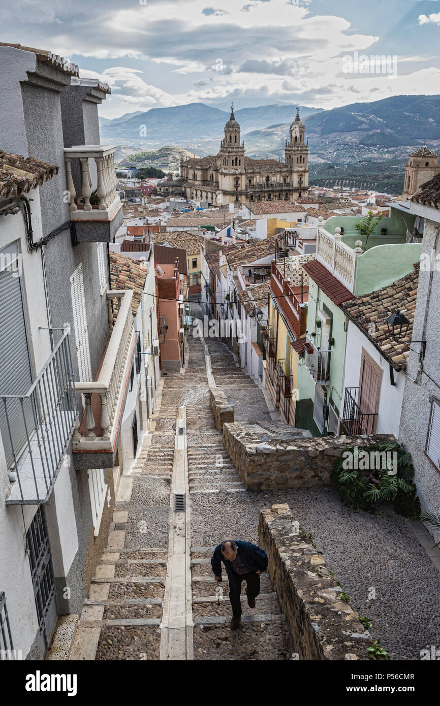 Narrow and steep street of Jaen Capital, in the background the city`s ...