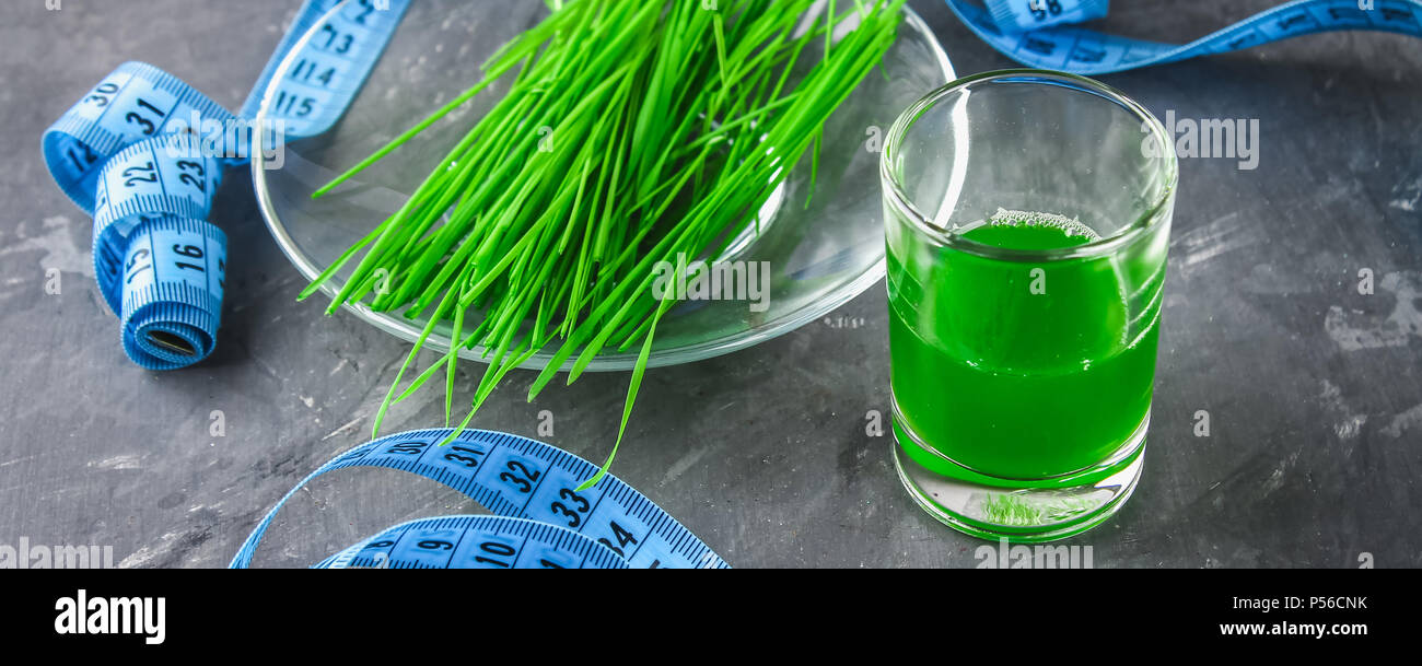 Wheatgrass shot. Juice from wheat grass. Trend of health Stock Photo ...