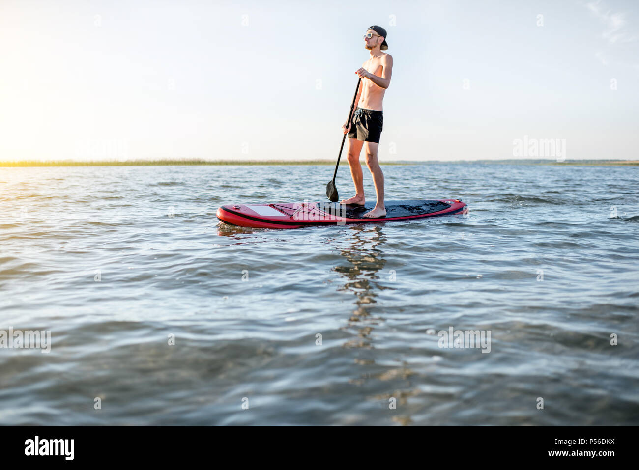 Man paddleboarding on the lake Stock Photo - Alamy