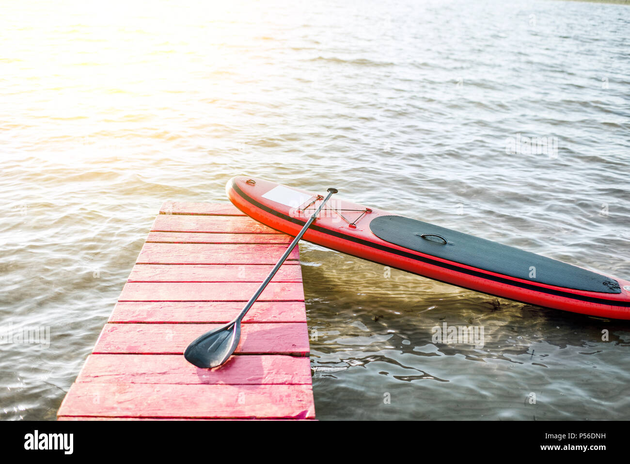 Red paddleboard at the lake Stock Photo - Alamy
