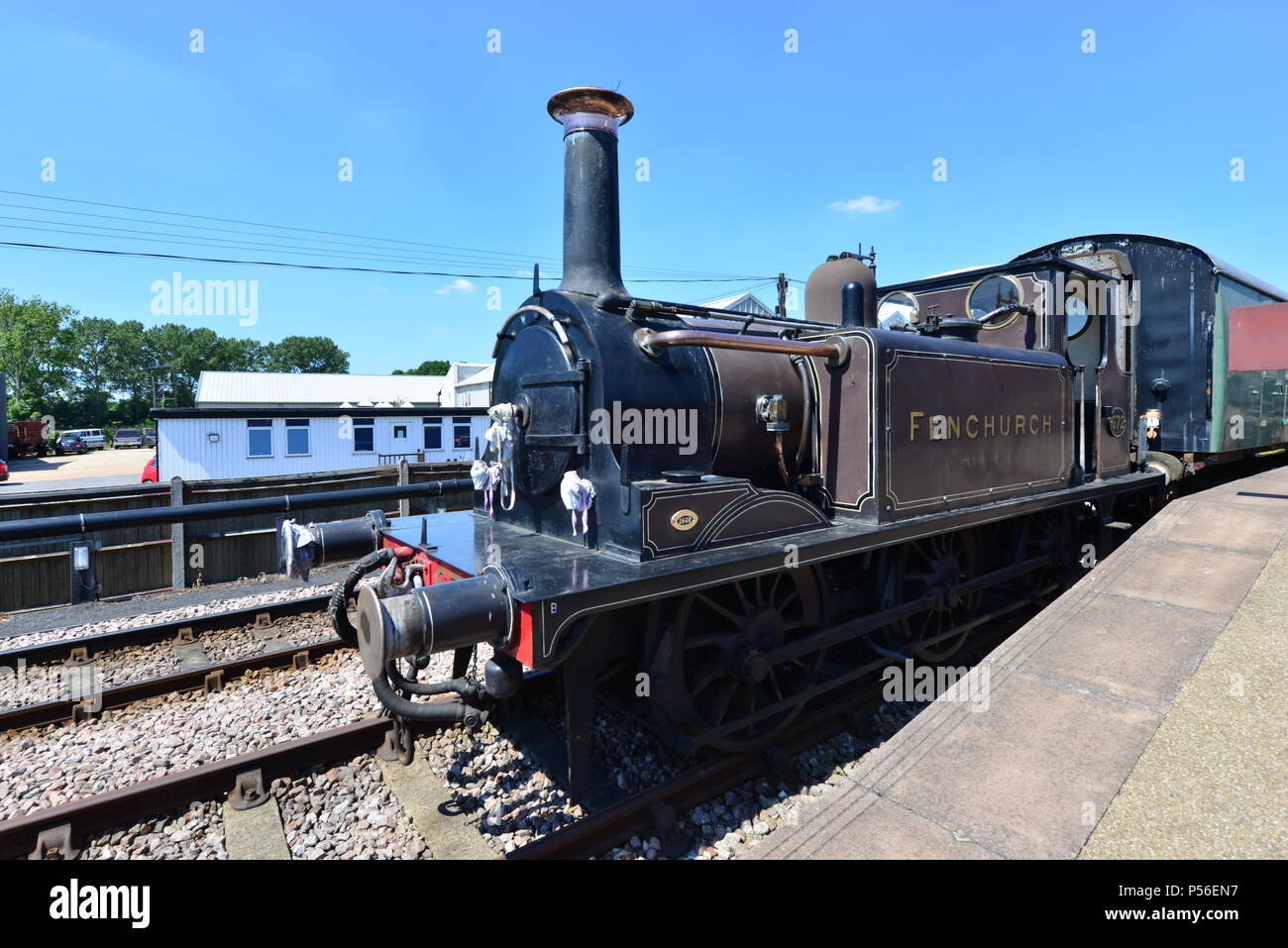 A brown shunting engine in a siding by a station Stock Photo - Alamy