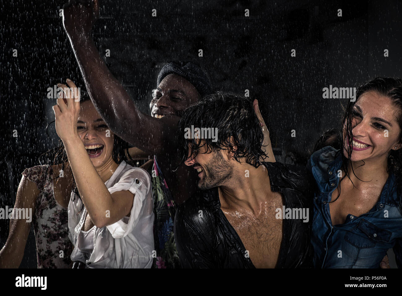 Groupof friends dncing in the rain Stock Photo - Alamy